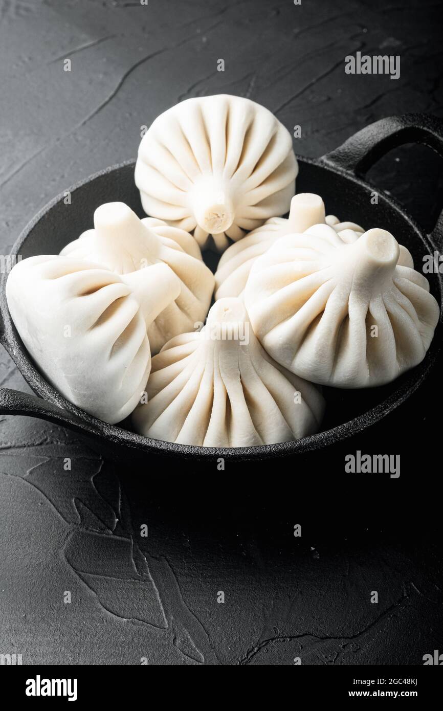 Delicious baozi, Chinese steamed meat bun set, in frying cast iron pan ...