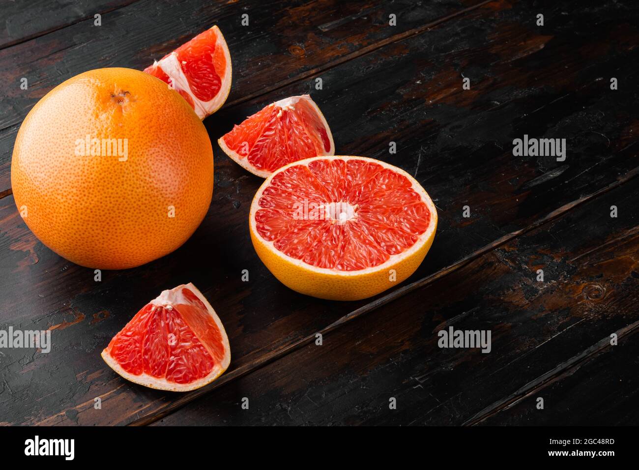 Grapefruit citrus fruit with half set, on old dark wooden table ...