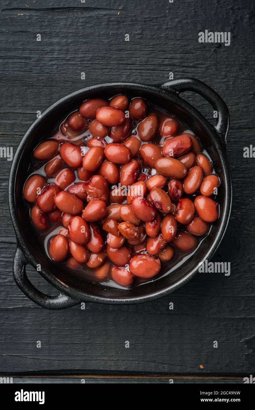 Red beans canned food, on black wooden table background, top view flat ...