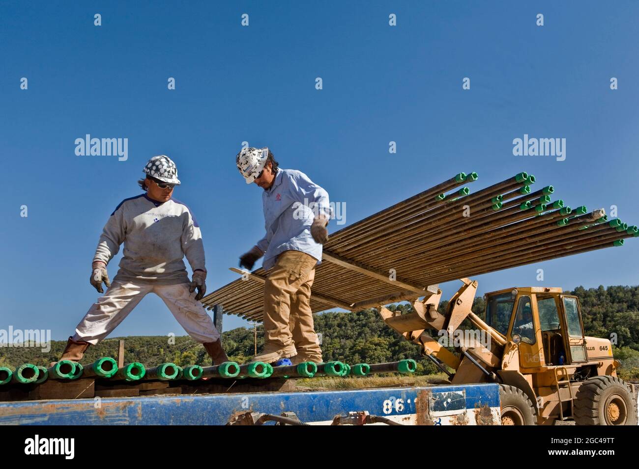 Loading drill pipe in oil-gas well area in Colorado Stock Photo - Alamy