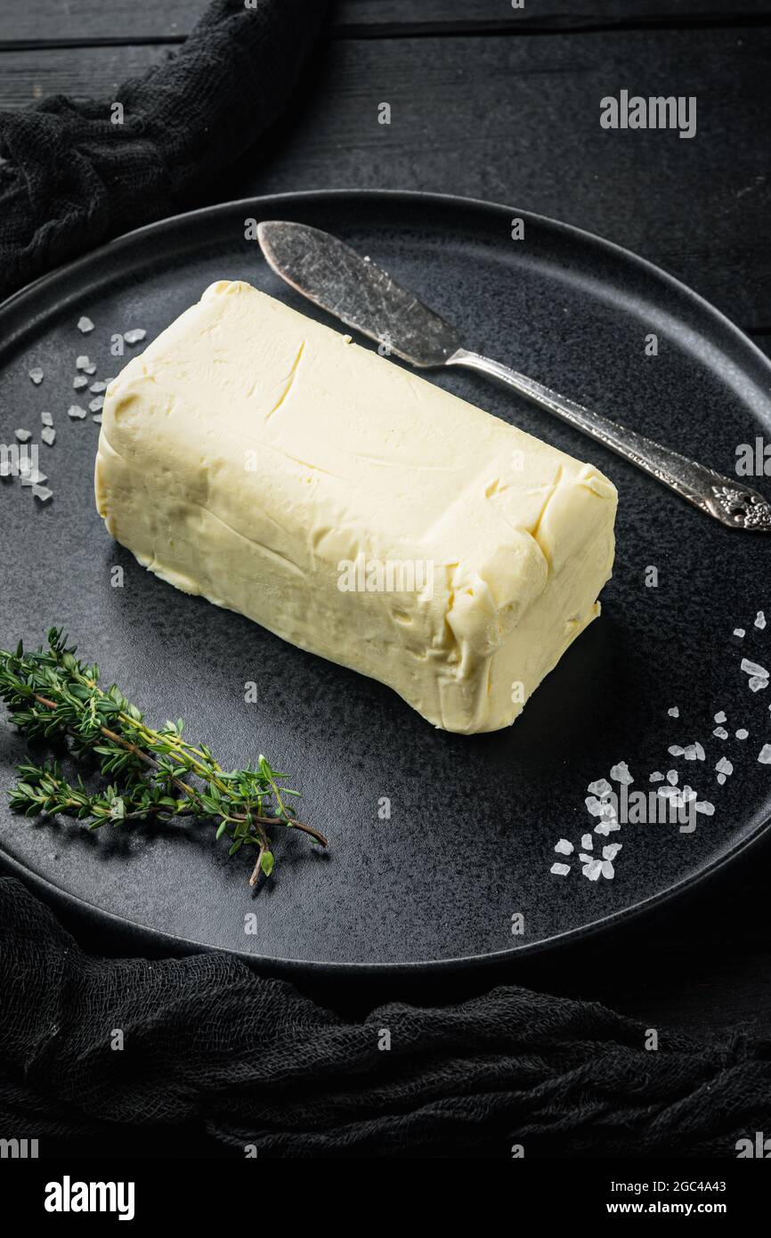 Rustic farmhouse inspired fresh butter, on black wooden table ...