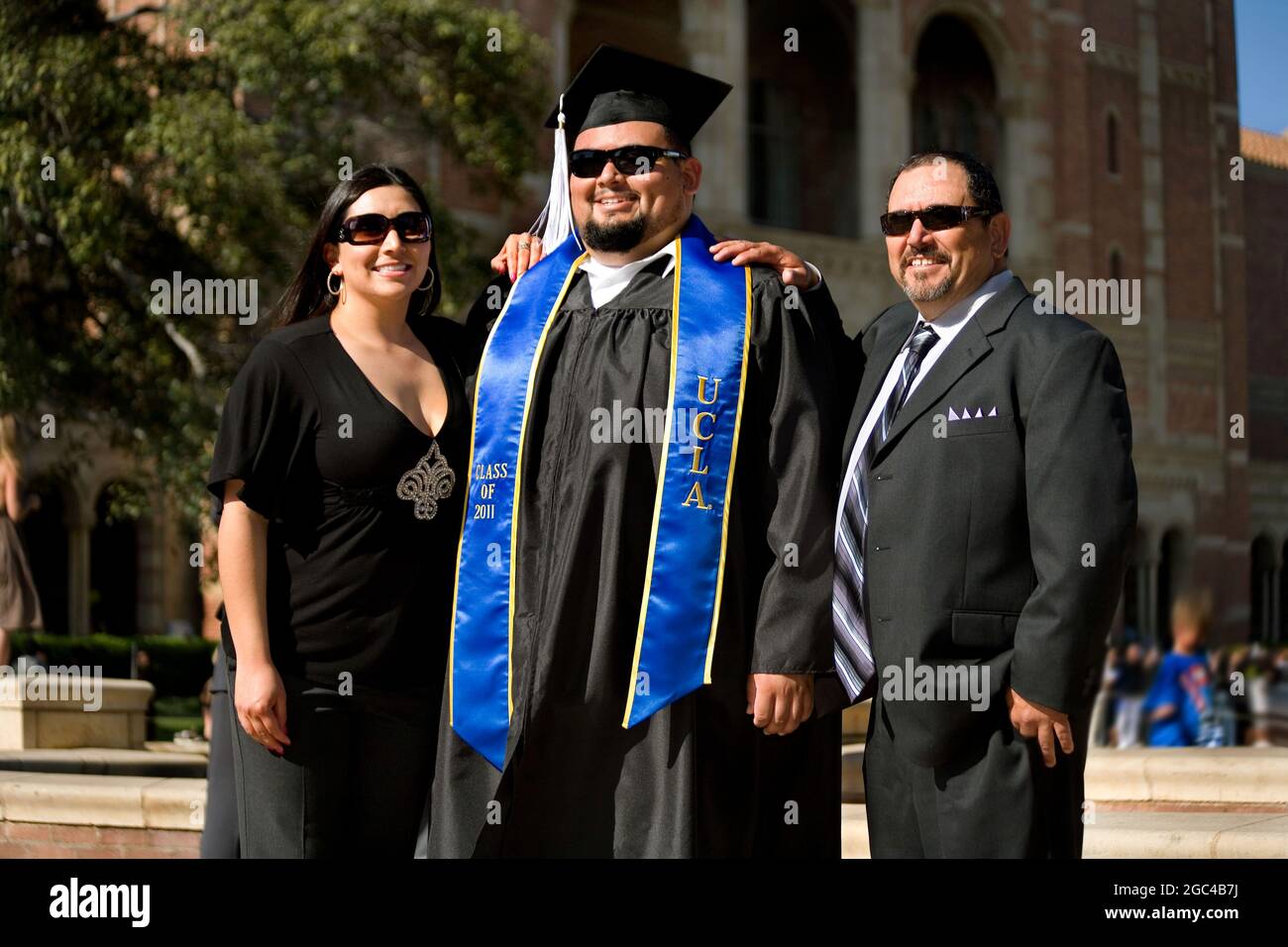 A young hispanic graduate with his father and sister H Stock Photo - Alamy