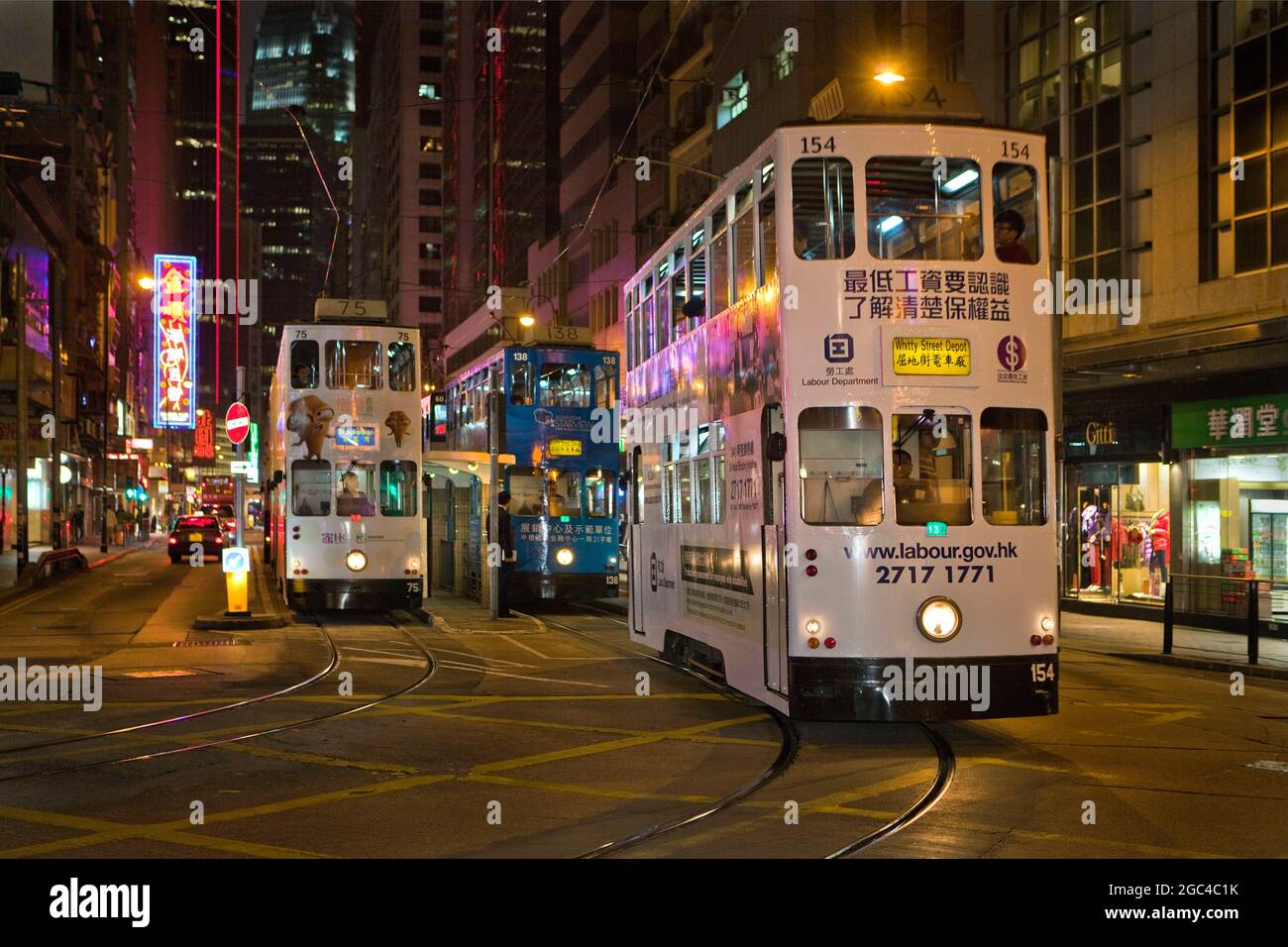 A night time look at busy double-decker buses in Hong Kong Stock Photo ...