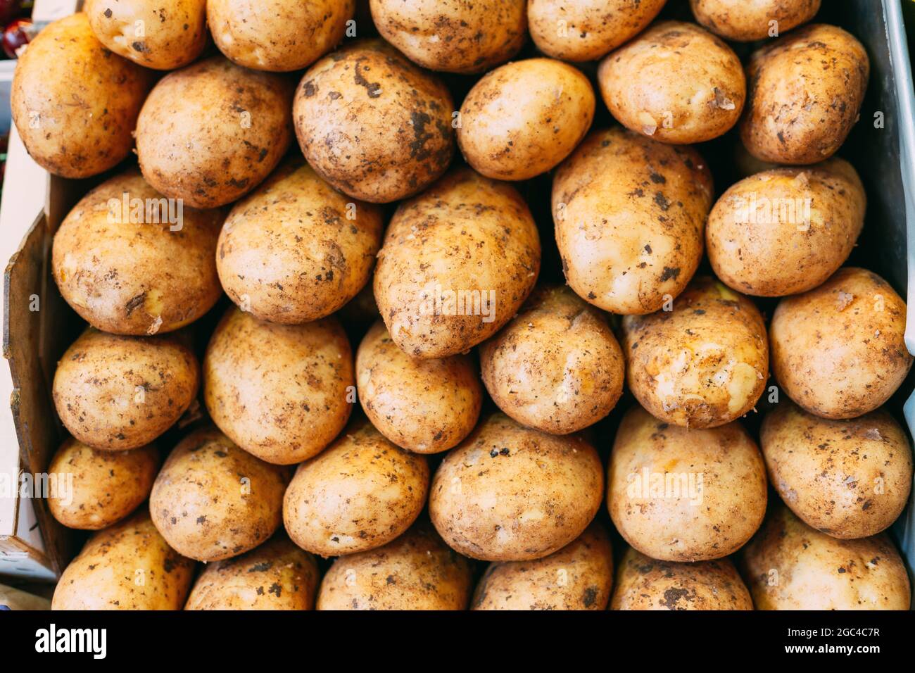 Potatoes forming background on farmers market Stock Photo - Alamy