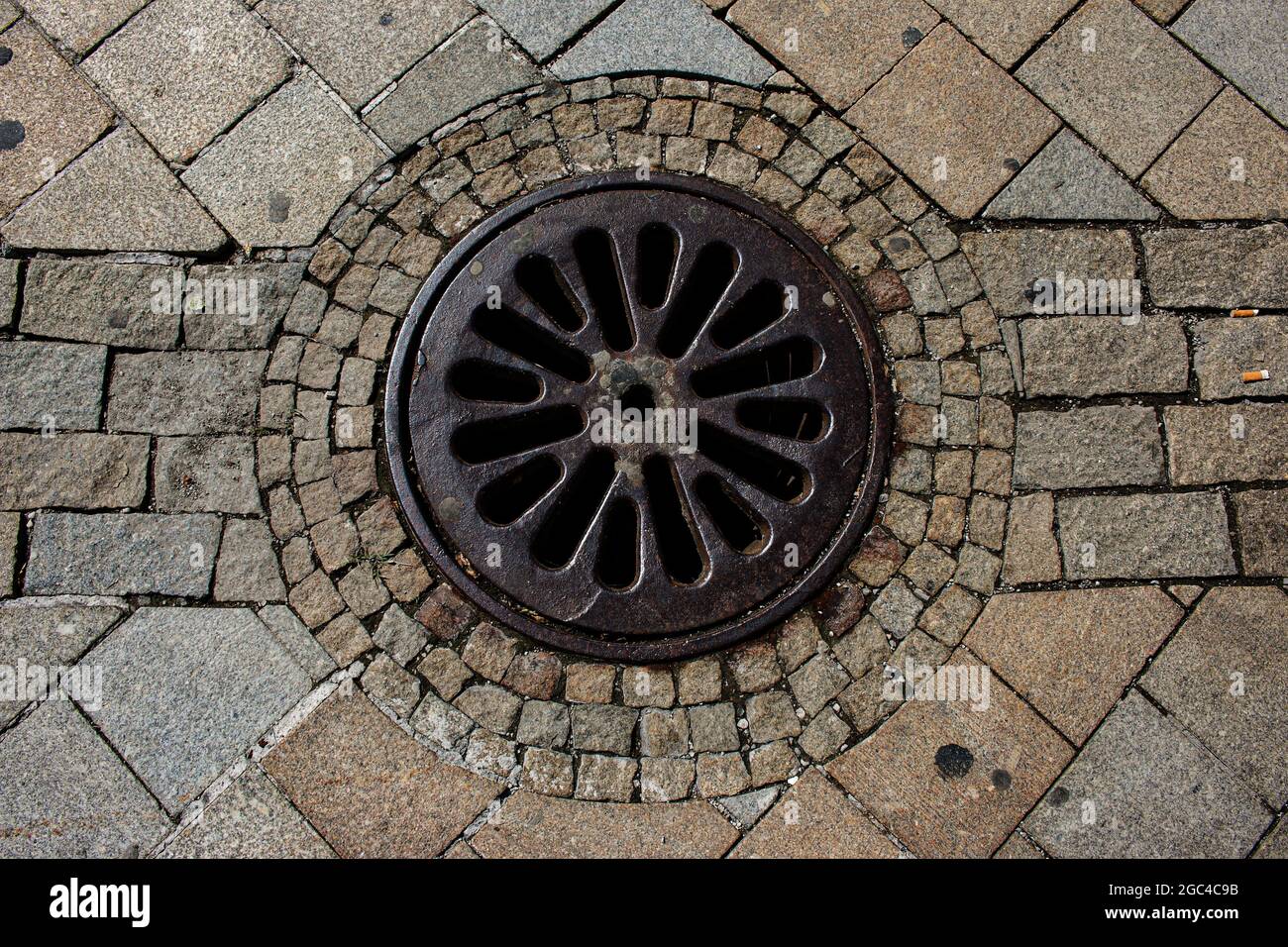 Sewer manhole on the urban asphalt road. Closeup photo Stock Photo - Alamy