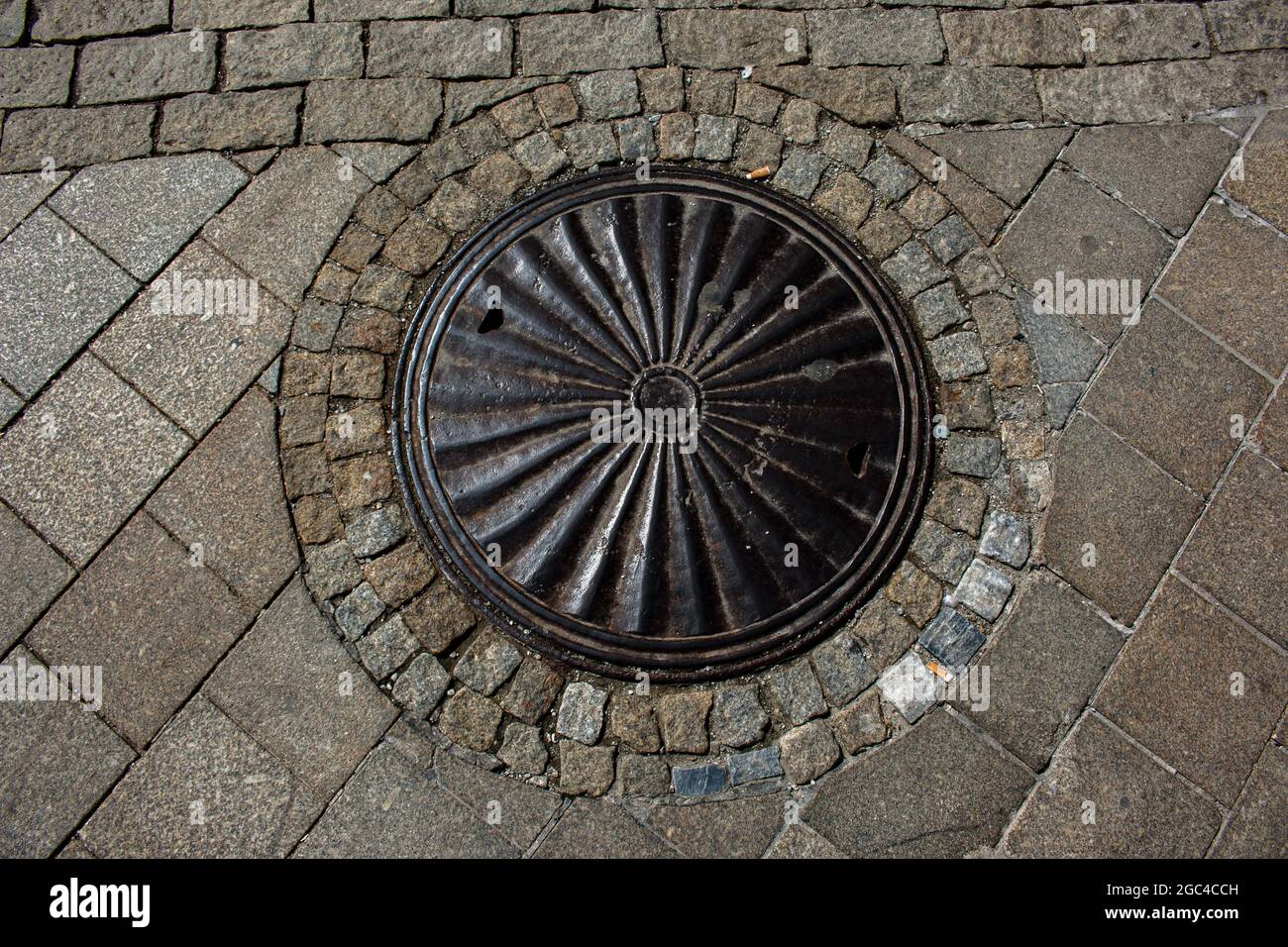 Sewer manhole on the urban asphalt road. Closeup photo Stock Photo - Alamy