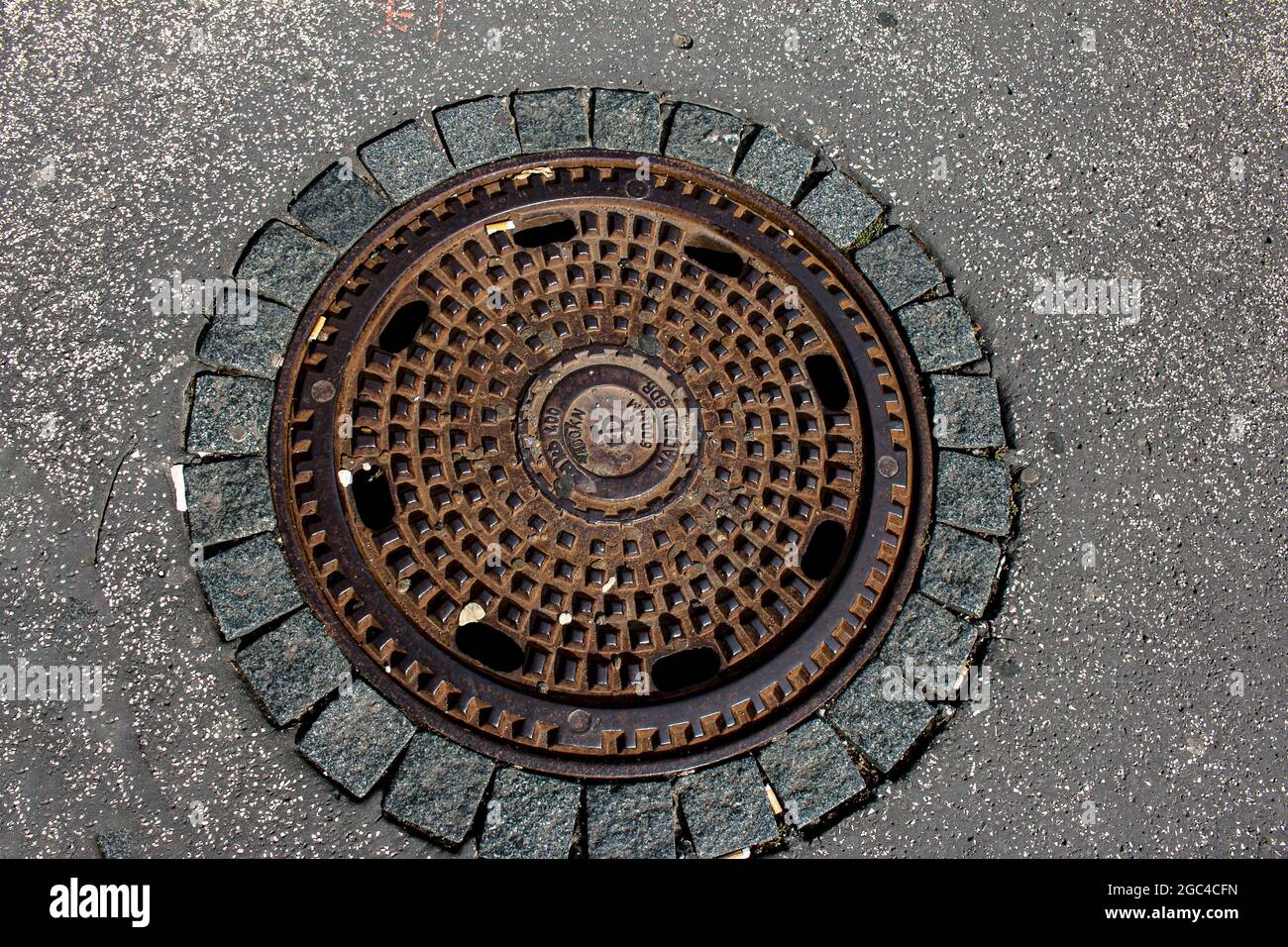 Sewer manhole on the urban asphalt road. Closeup photo Stock Photo - Alamy