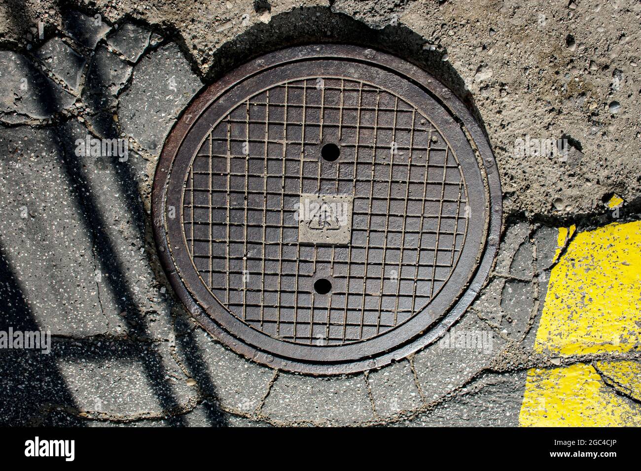 Sewer manhole on the urban asphalt road. Closeup photo Stock Photo - Alamy