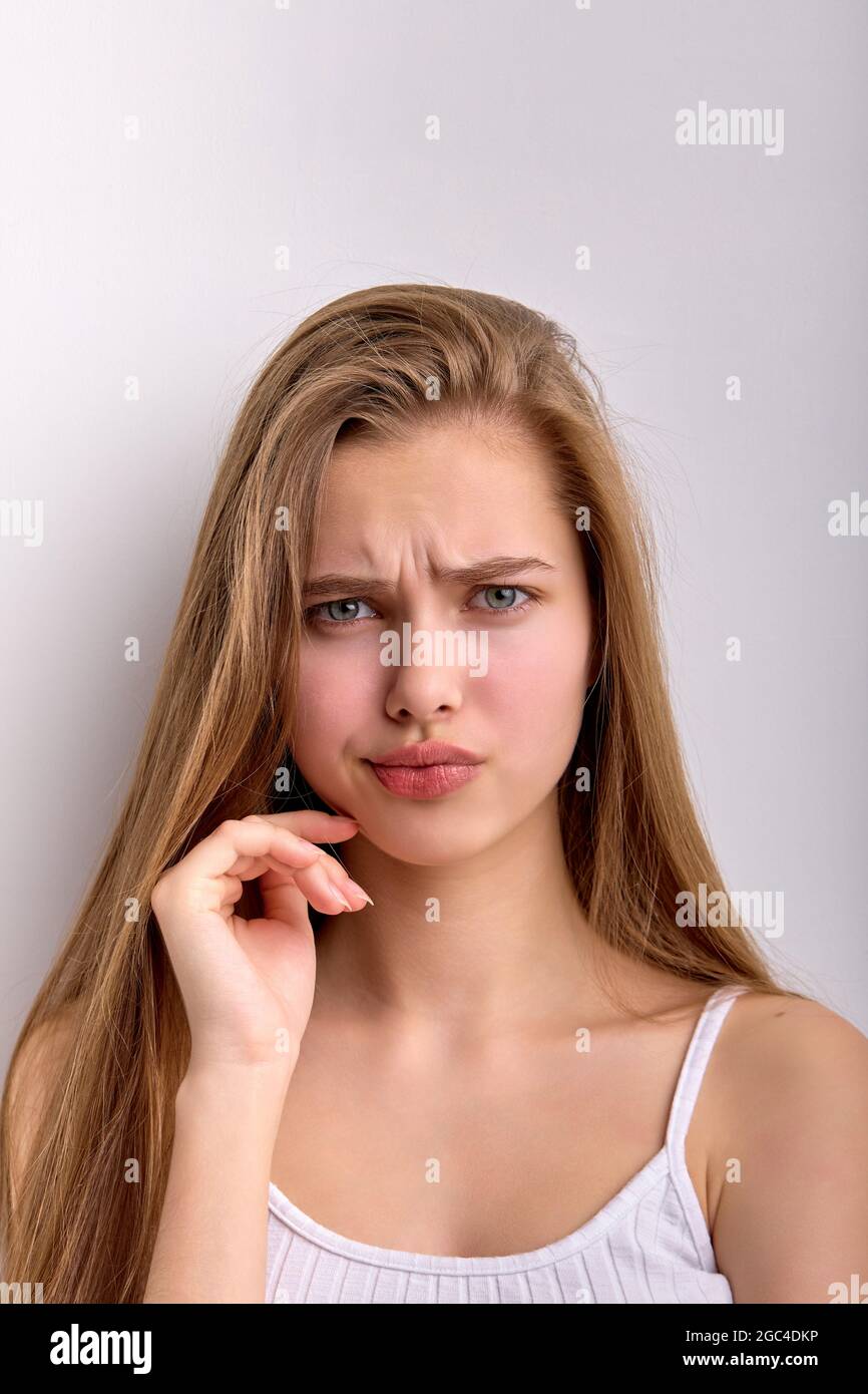 Puzzled perplexed female is dissatisfied with something, looking ...