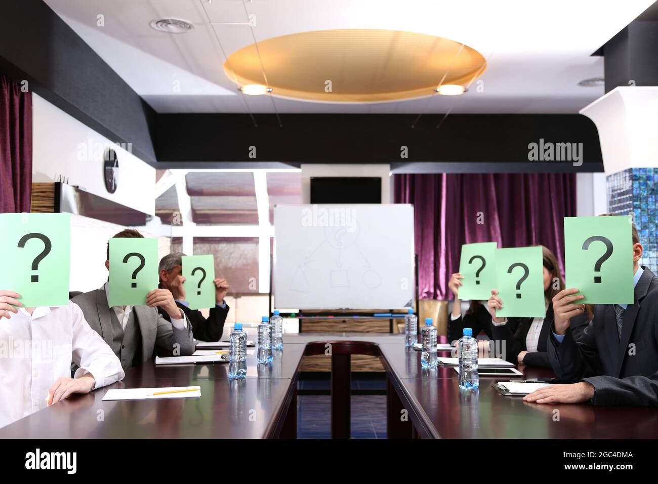 Businessmen with question marks on their faces before business training ...