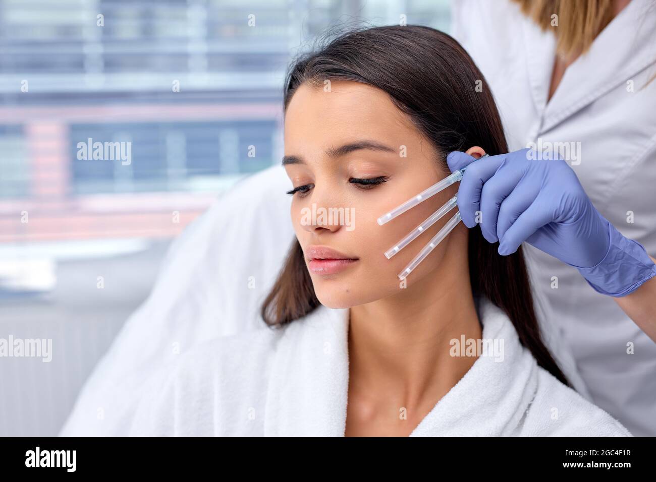 Side view close-up photo of young brunette female came to cosmetologist ...