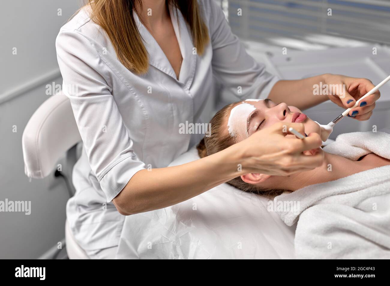 Beautiful caucasian client at beautician getting spa procedures, facial ...