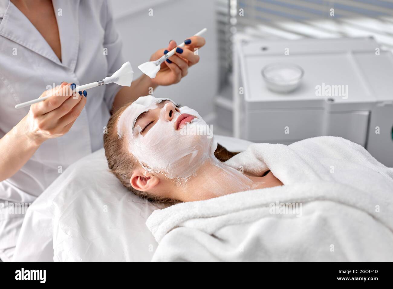 Cropped confident doctor cosmetologist or dermatologist making face ...