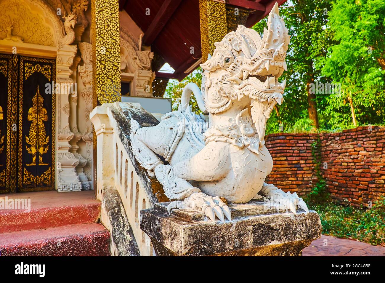 The white stucco Singha Lion sculpture at the entrance to the Viharn of ...