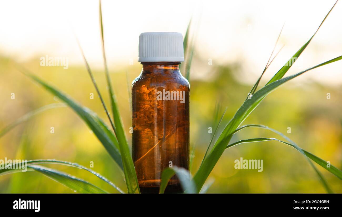 Medical bottle in the grass - blurry background Stock Photo - Alamy