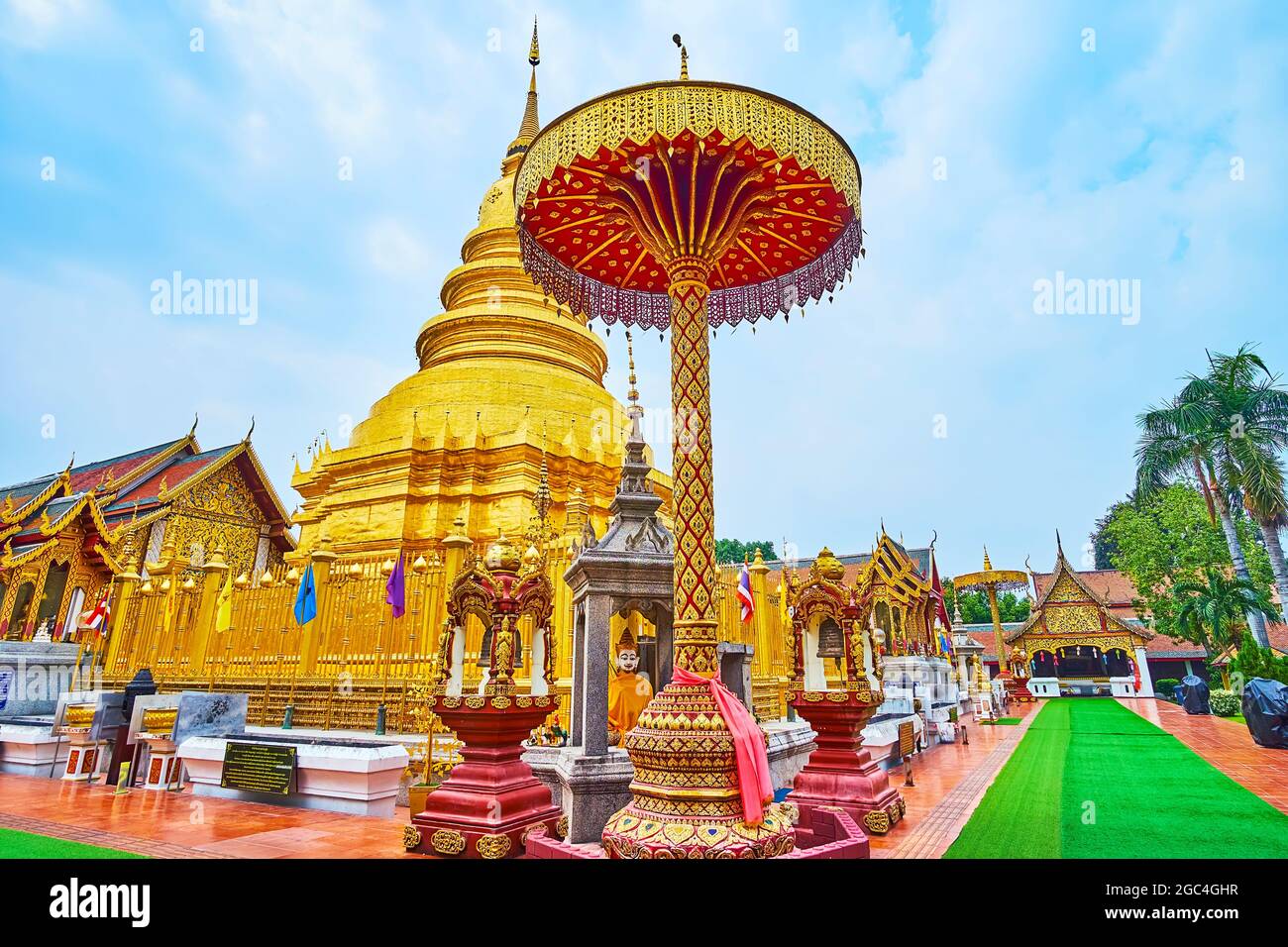 The Phra Maha That Chedi of Wat Phra That Hariphunchai Temple is surrounded with gilt fence ...