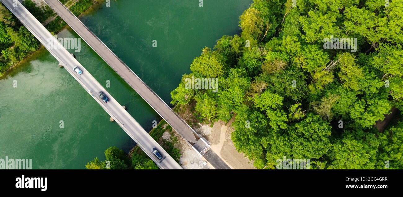 Aerial shot of bridge roads over a river surrounded by greenery Stock ...