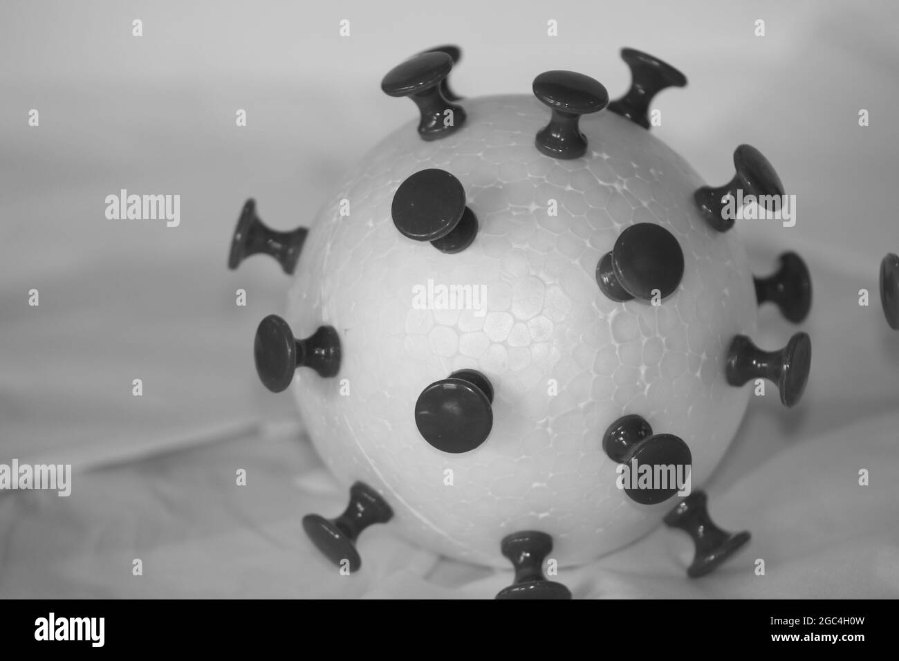 Grayscale shot of a COVID particle model made with paper pins and ...