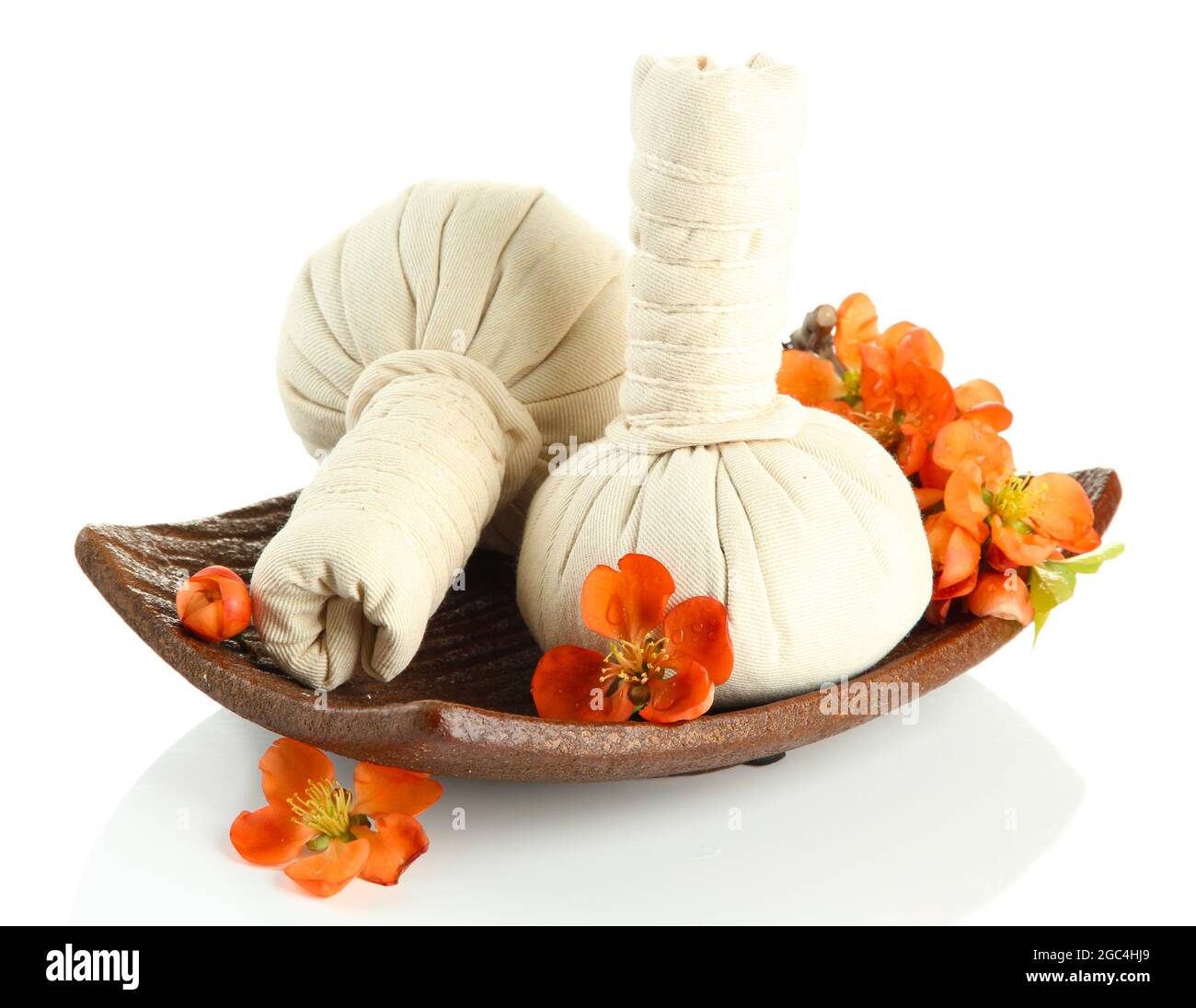 Herbal compress balls for spa treatment and flowers isolated on white ...