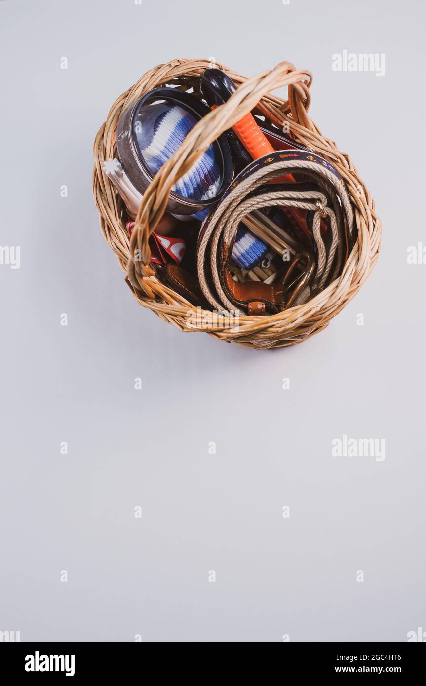 Top view of a woven basket full of Hiking tools on a light isolated ...