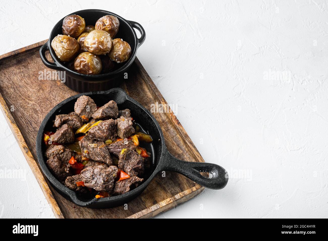 Meat stew with sweet bell pepper and bay leaf set, in cast iron frying ...