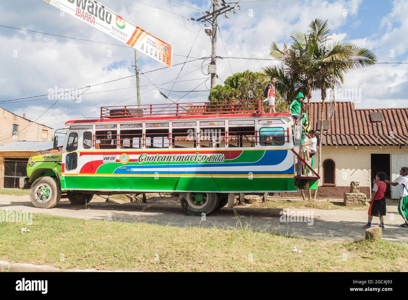 SAN JOSE DE ISNOS, COLOMBIA - SEPTEMBER 14, 2015: Colorful chiva buses ...