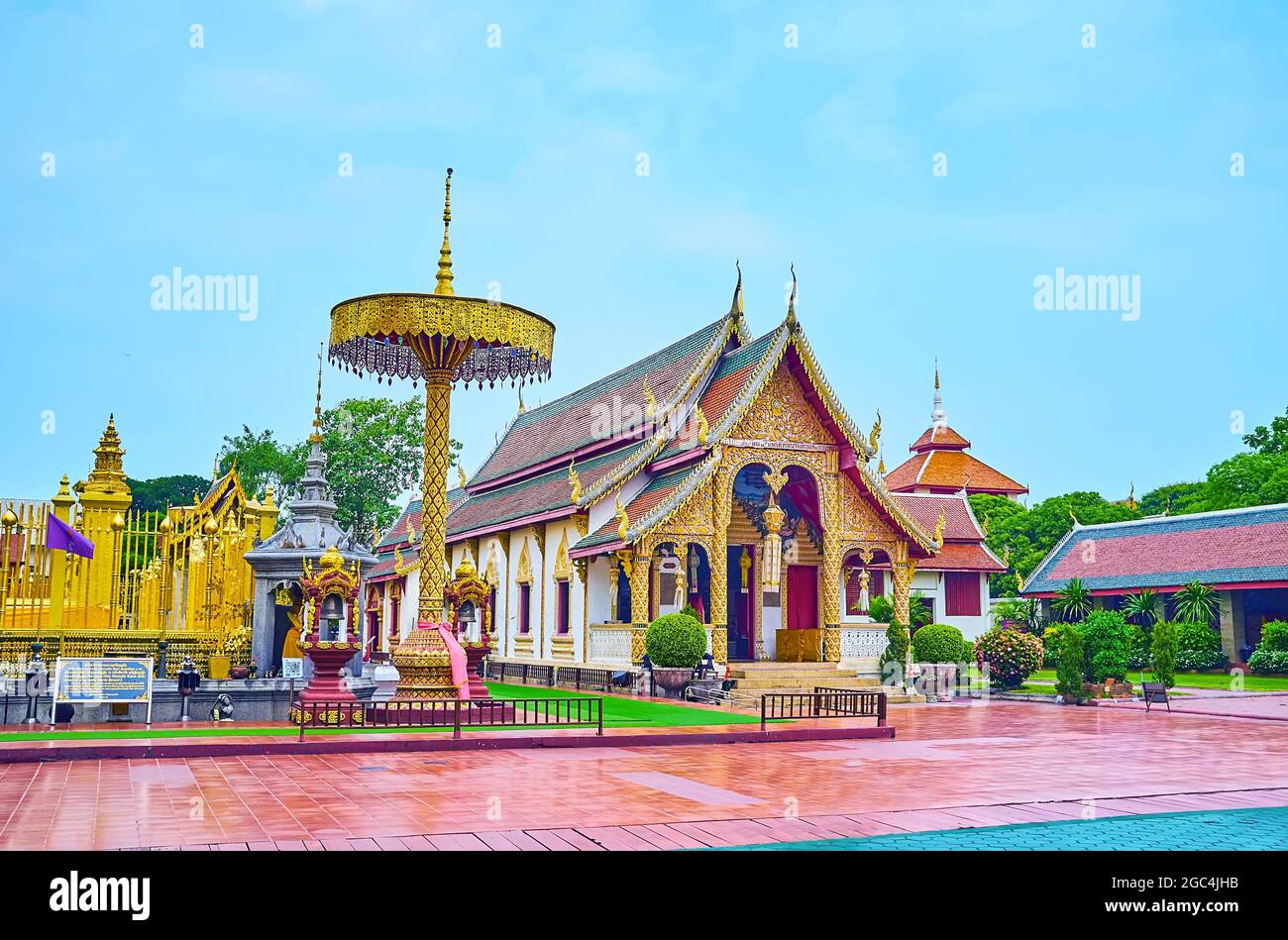 The ornate shrine of Phra Chao Lawo with chatra ceremonial umbrella ...