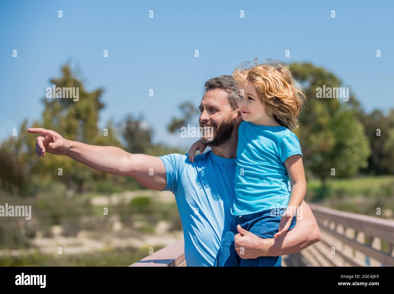happy father directing showing something his child outdoor, childhood ...