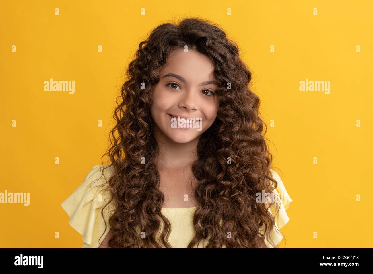 nice girl has wavy hairdo. portrait of frizz child. express positive ...