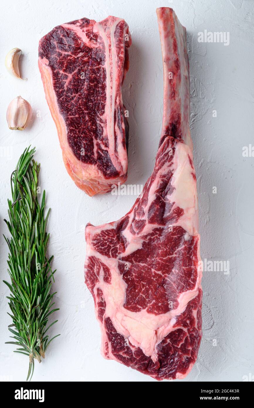 Raw fresh tomahawk dry aged marbled beef chop steak set, on white stone ...