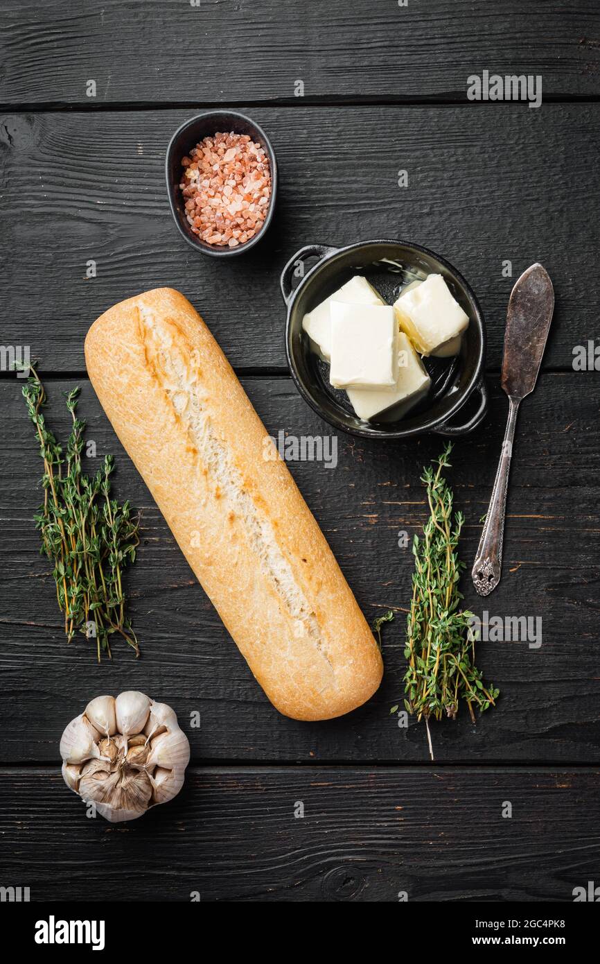 Garlic bread compound butter and herb ingredients set, on black wooden ...