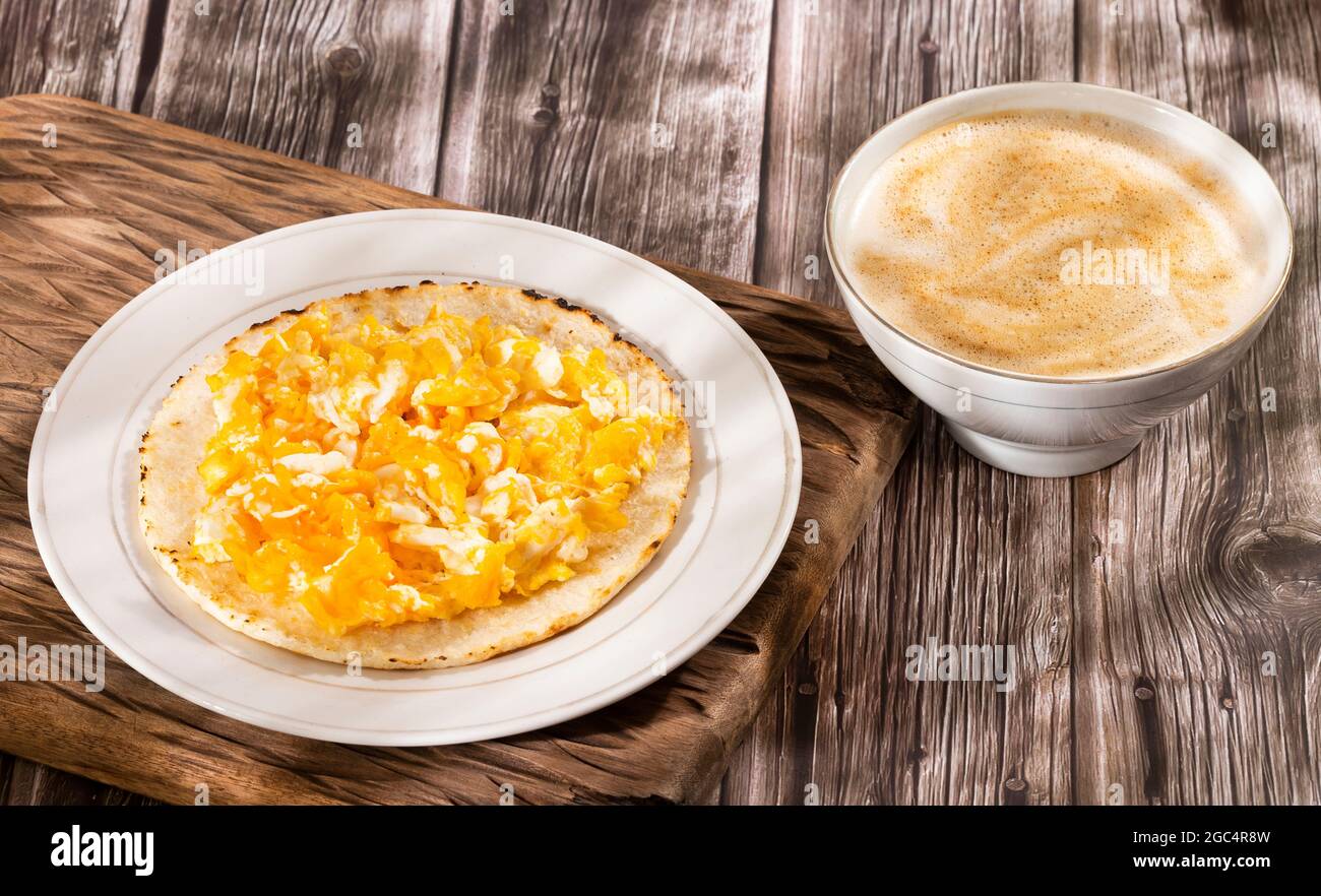 Traditional Colombian breakfast - Arepa and egg Stock Photo - Alamy