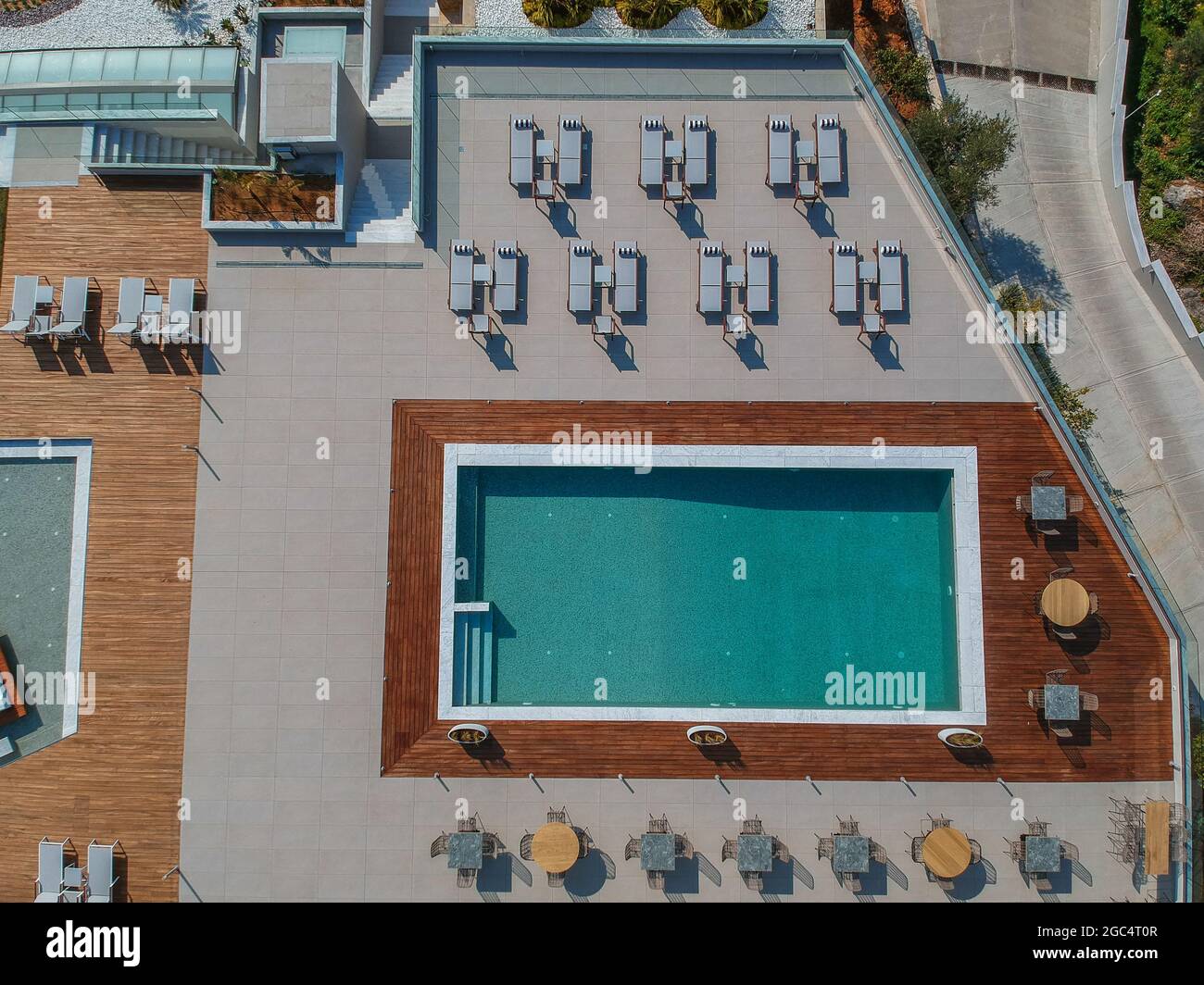 Top down aerial view of hotel swimming pool with crystal blue water and ...