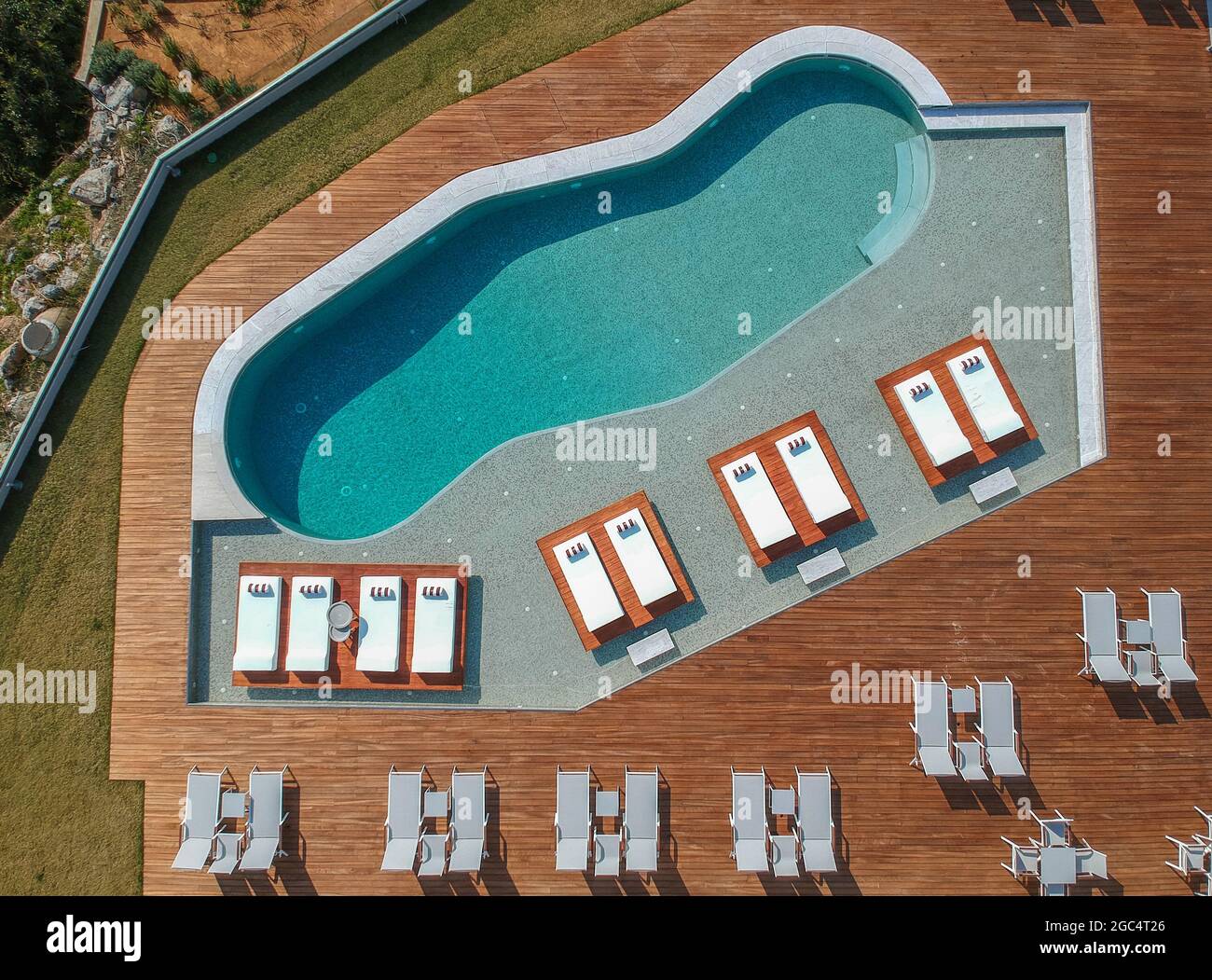 Top down aerial view of hotel swimming pool with crystal blue water and ...