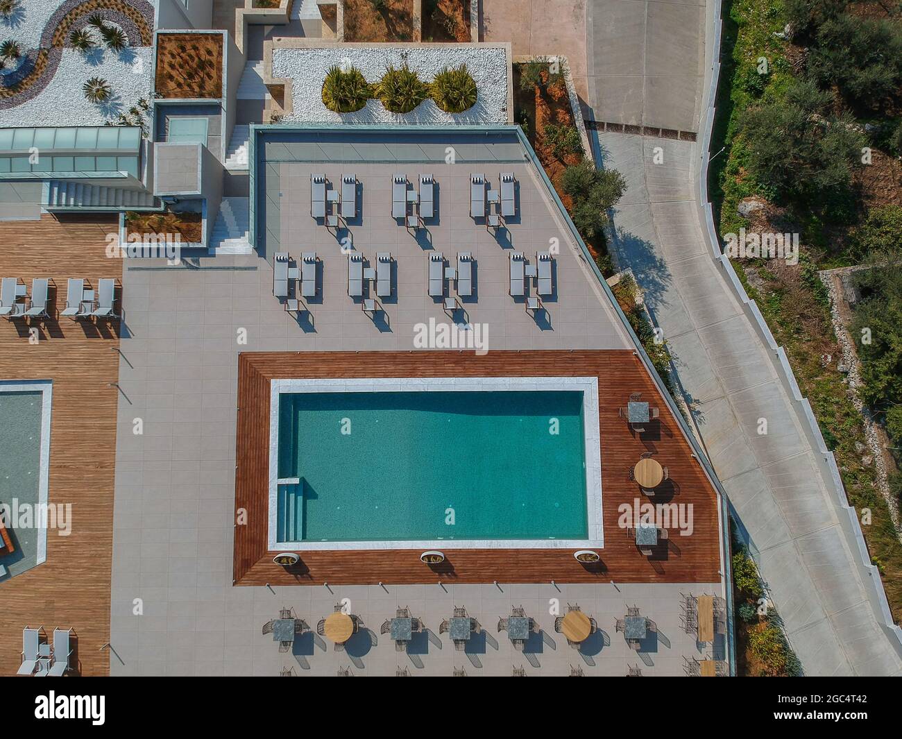 Top down aerial view of hotel swimming pool with crystal blue water and ...
