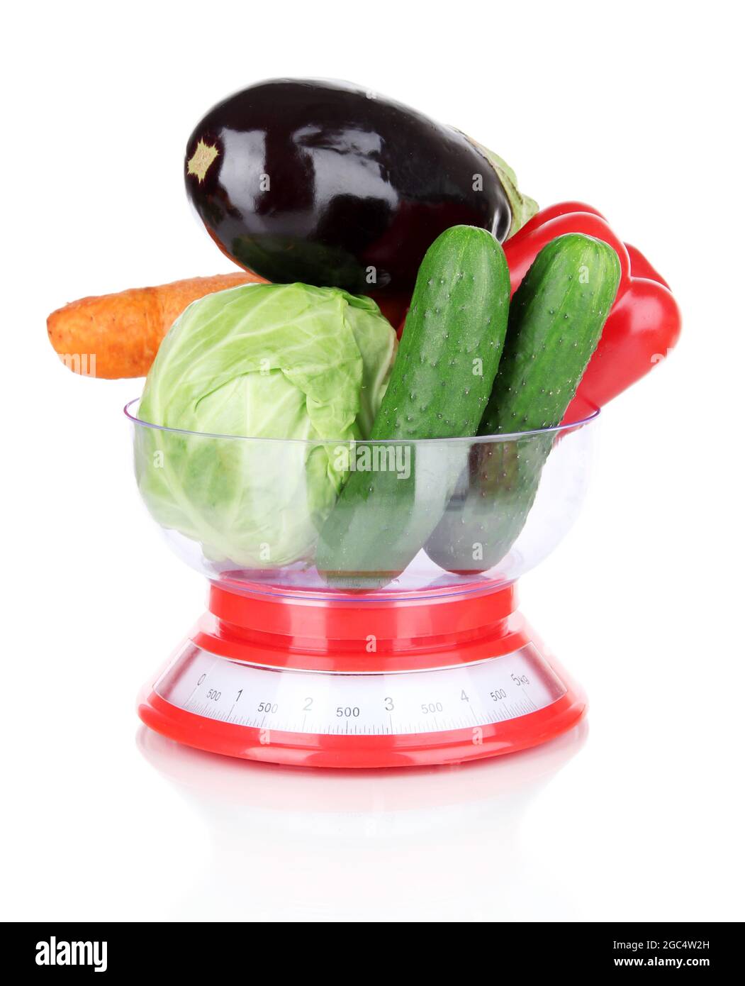 Fresh vegetables in scales isolated on white Stock Photo - Alamy