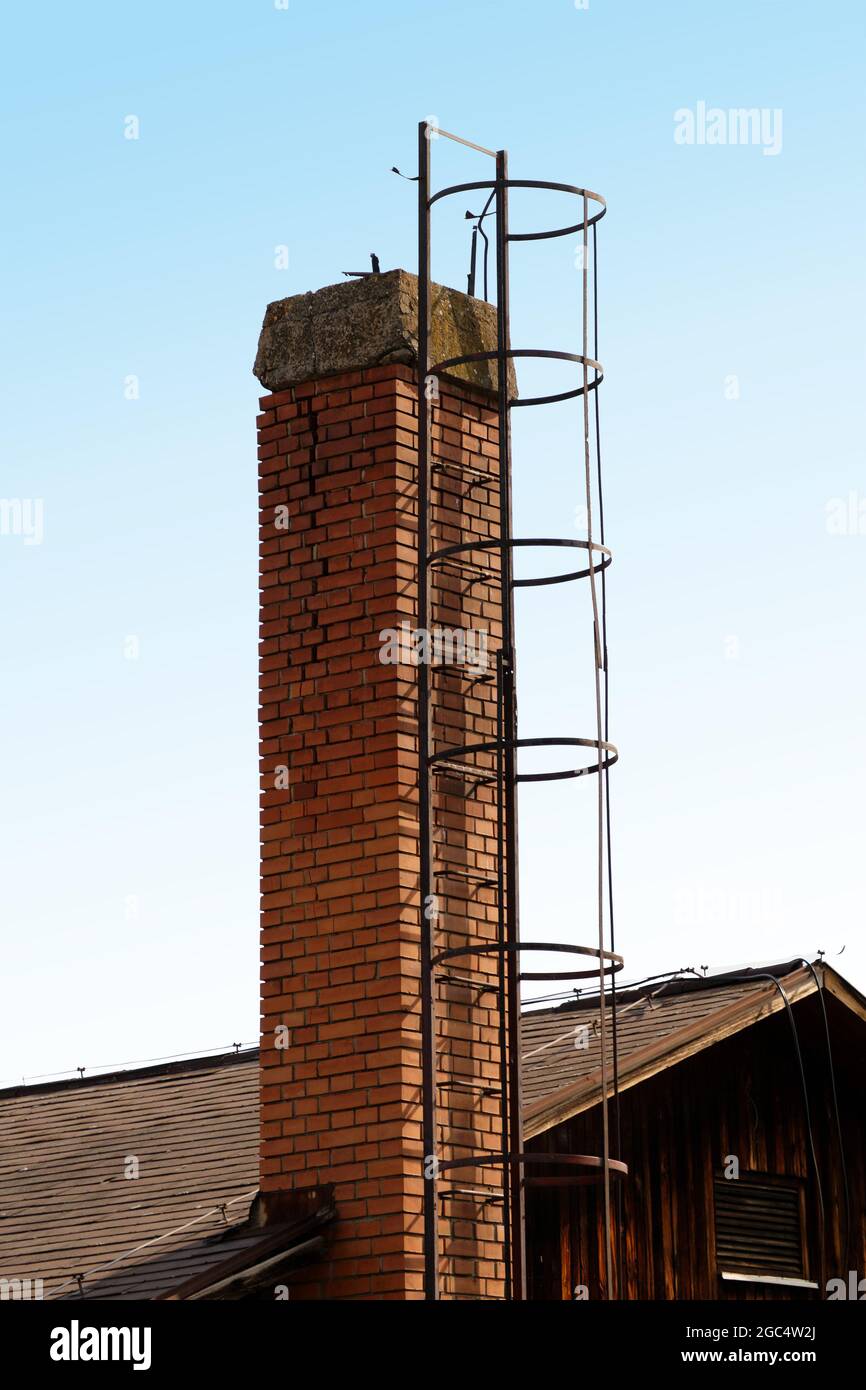 Brick chimney with safety ladder on old house exterior Stock Photo - Alamy