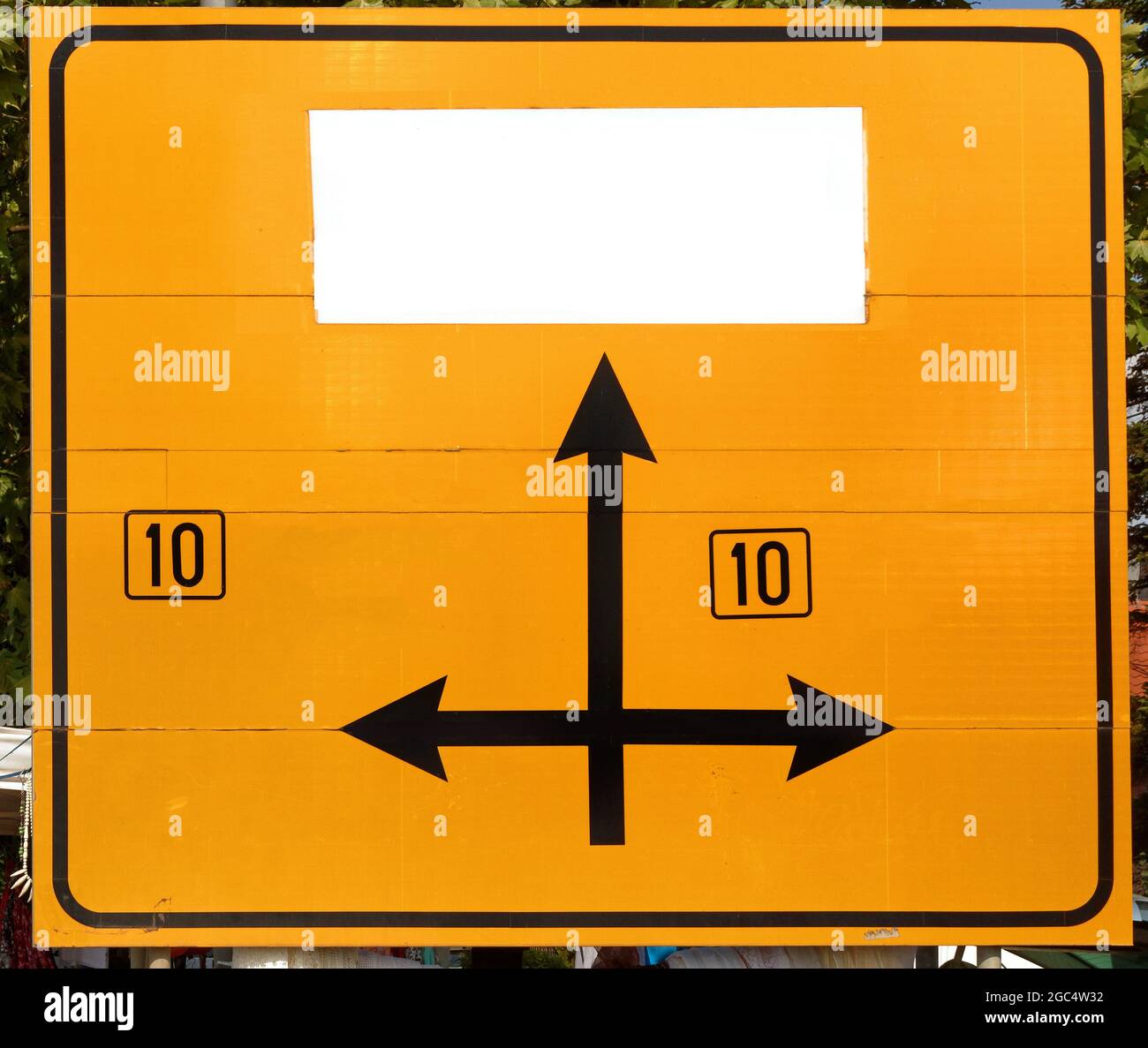 Yellow traffic road sign with arrows showing directions Stock Photo - Alamy