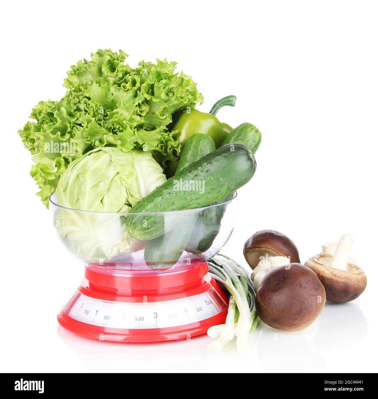 Fresh vegetables in scales isolated on white Stock Photo - Alamy