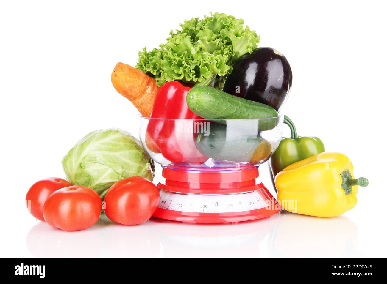 Fresh vegetables in scales isolated on white Stock Photo - Alamy