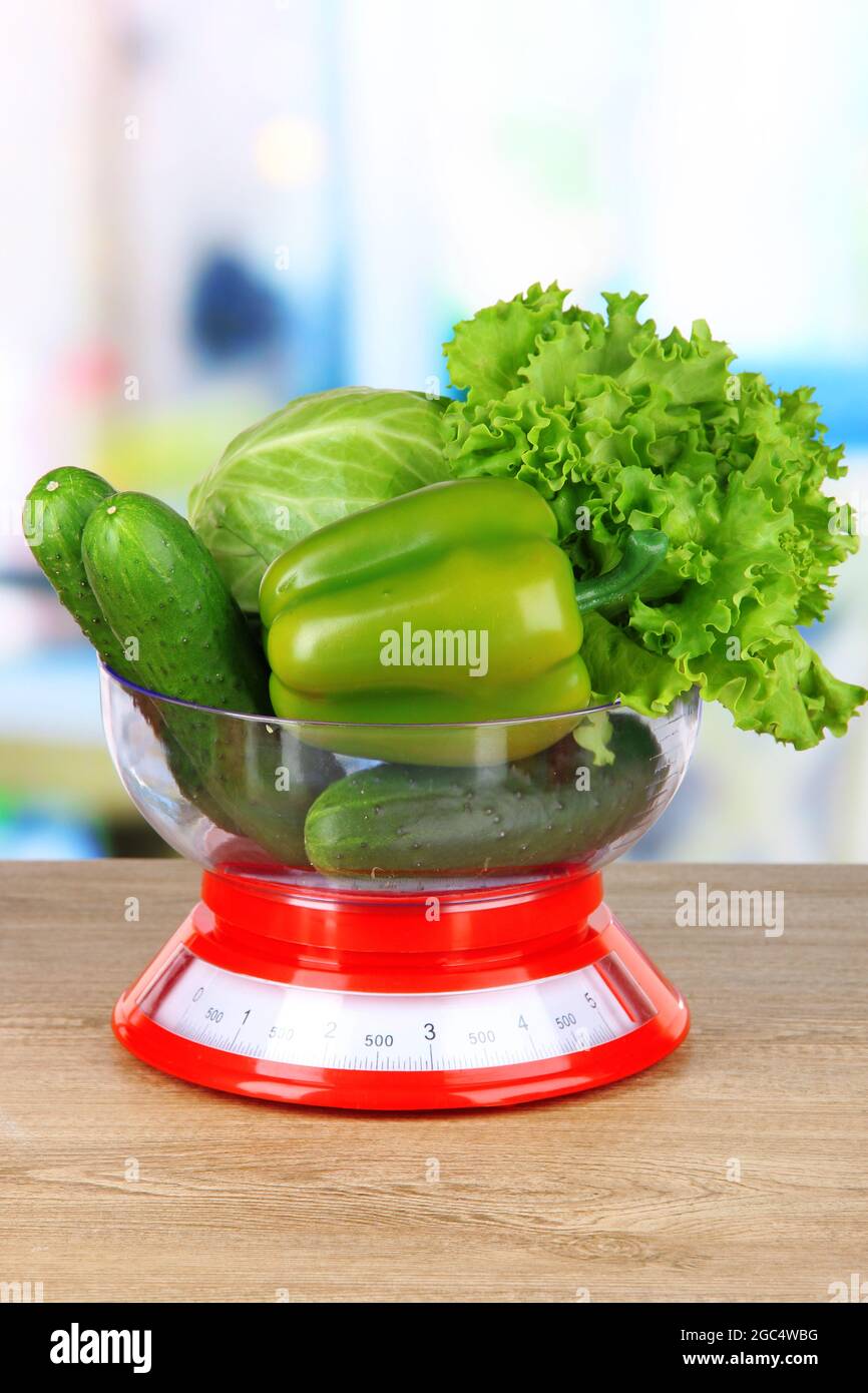 Fresh vegetables in scales on table in kitchen Stock Photo - Alamy