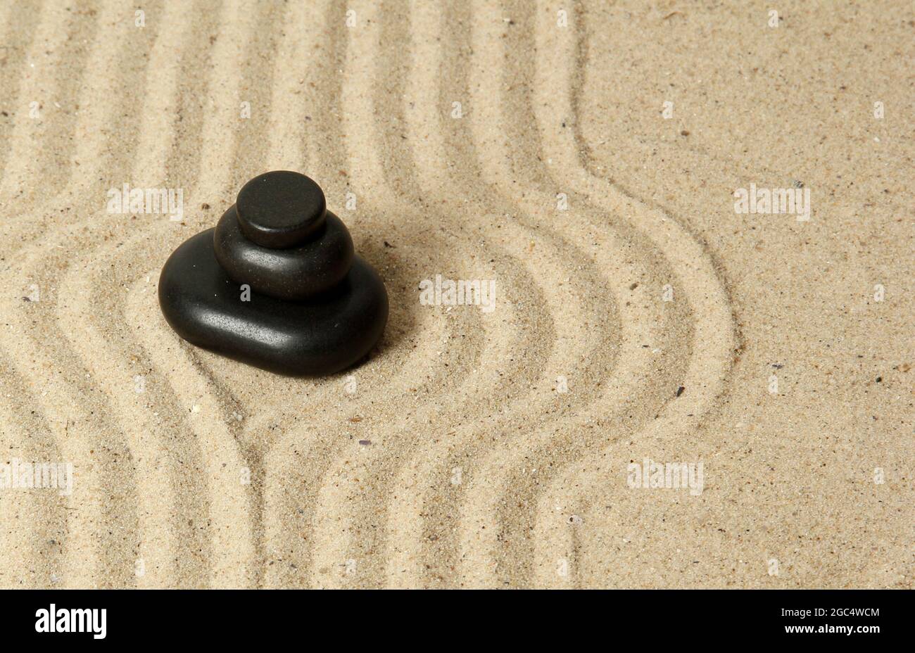 Zen garden with raked sand and round stones close up Stock Photo - Alamy
