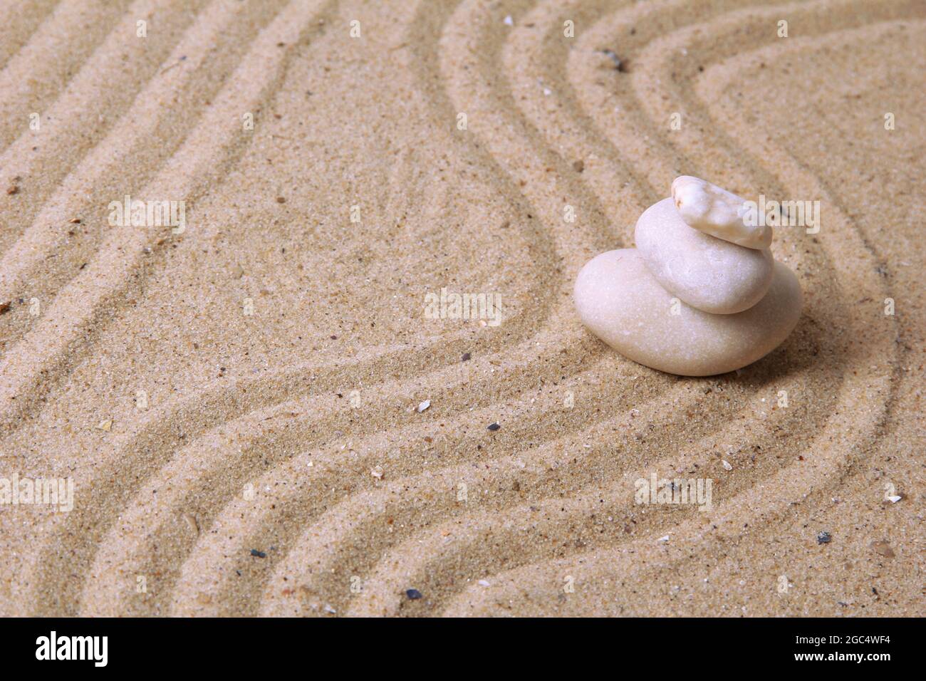 Zen garden with raked sand and round stones close up Stock Photo - Alamy