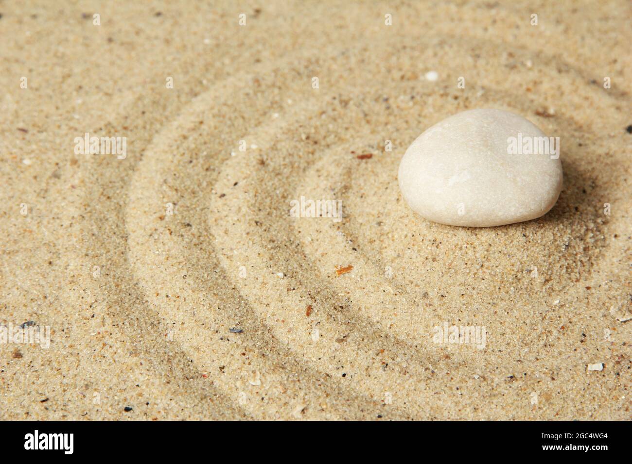 Zen garden with raked sand and stone close up Stock Photo - Alamy