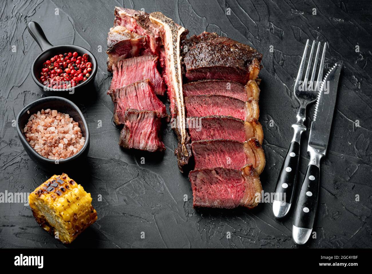 Porterhouse steak is grilled sliced on a piece set, on black stone ...