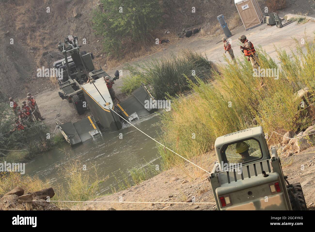 National Guardsmen build temporary bridge across waterway during ...