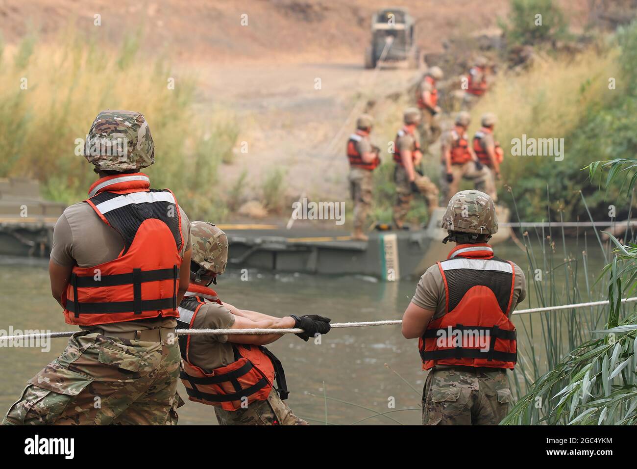 National Guardsmen build temporary bridge across waterway during ...