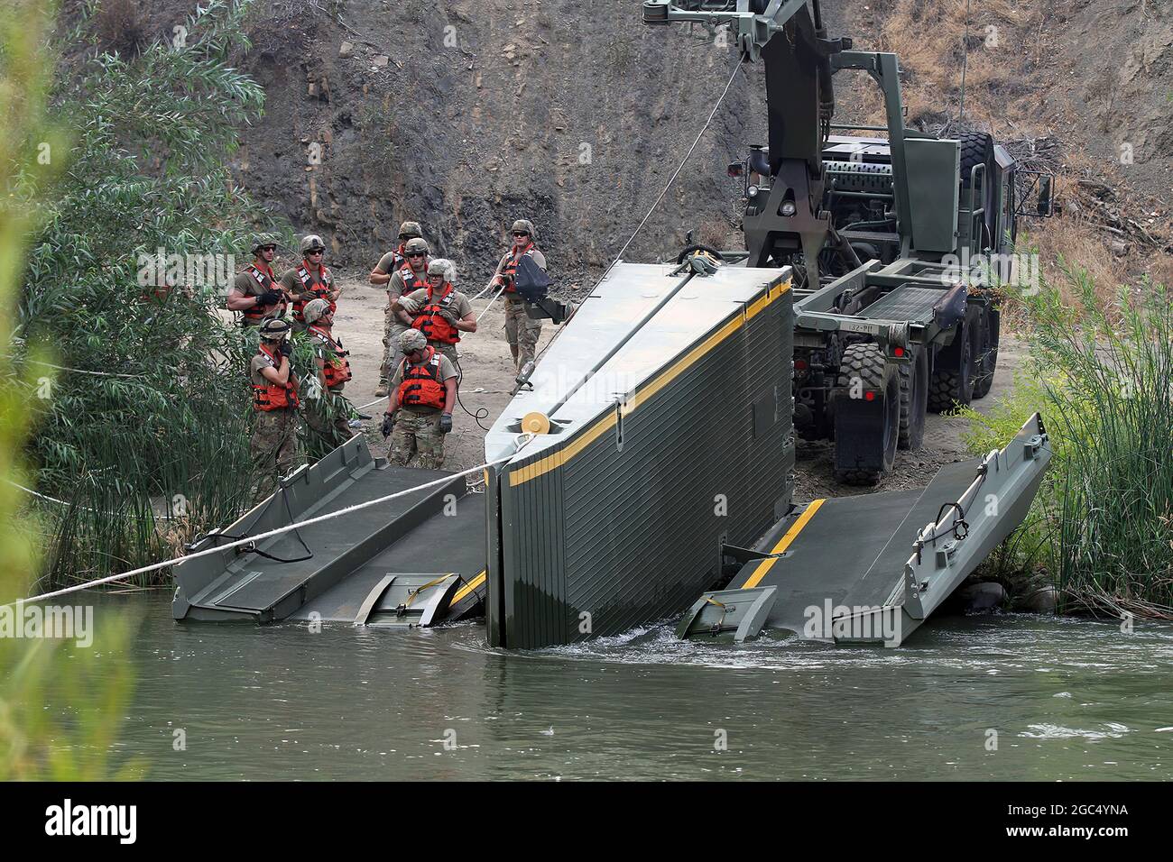 National Guardsmen build temporary bridge across waterway during ...
