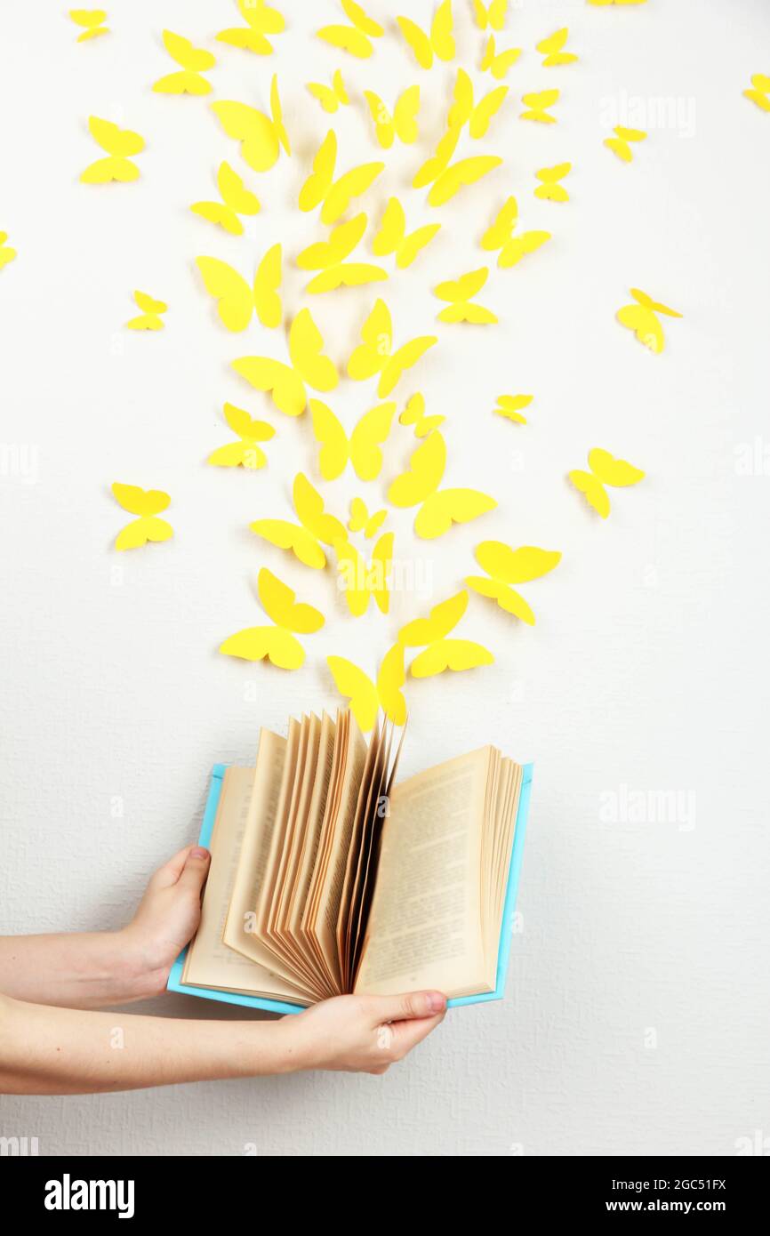 Paper yellow butterflies fly out of book Stock Photo - Alamy