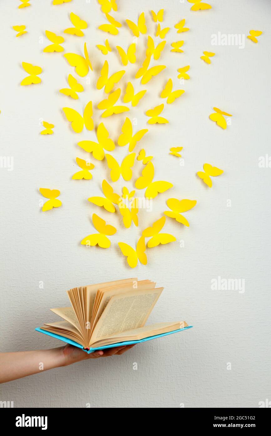 Paper yellow butterflies fly out of book Stock Photo - Alamy